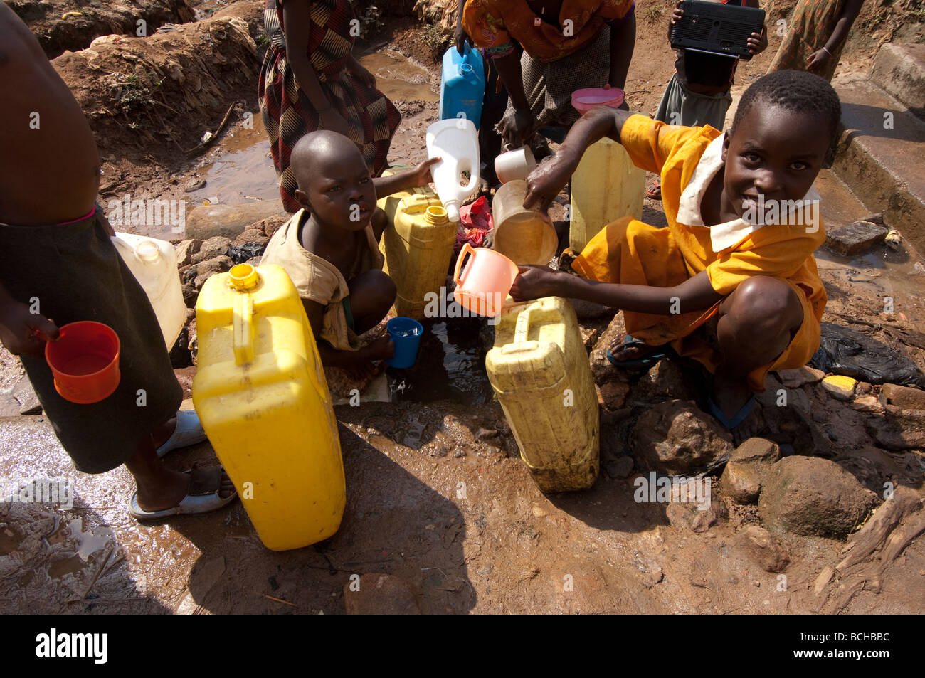 Children collecting water from contaminated spring. Kamwockya Kampala ...