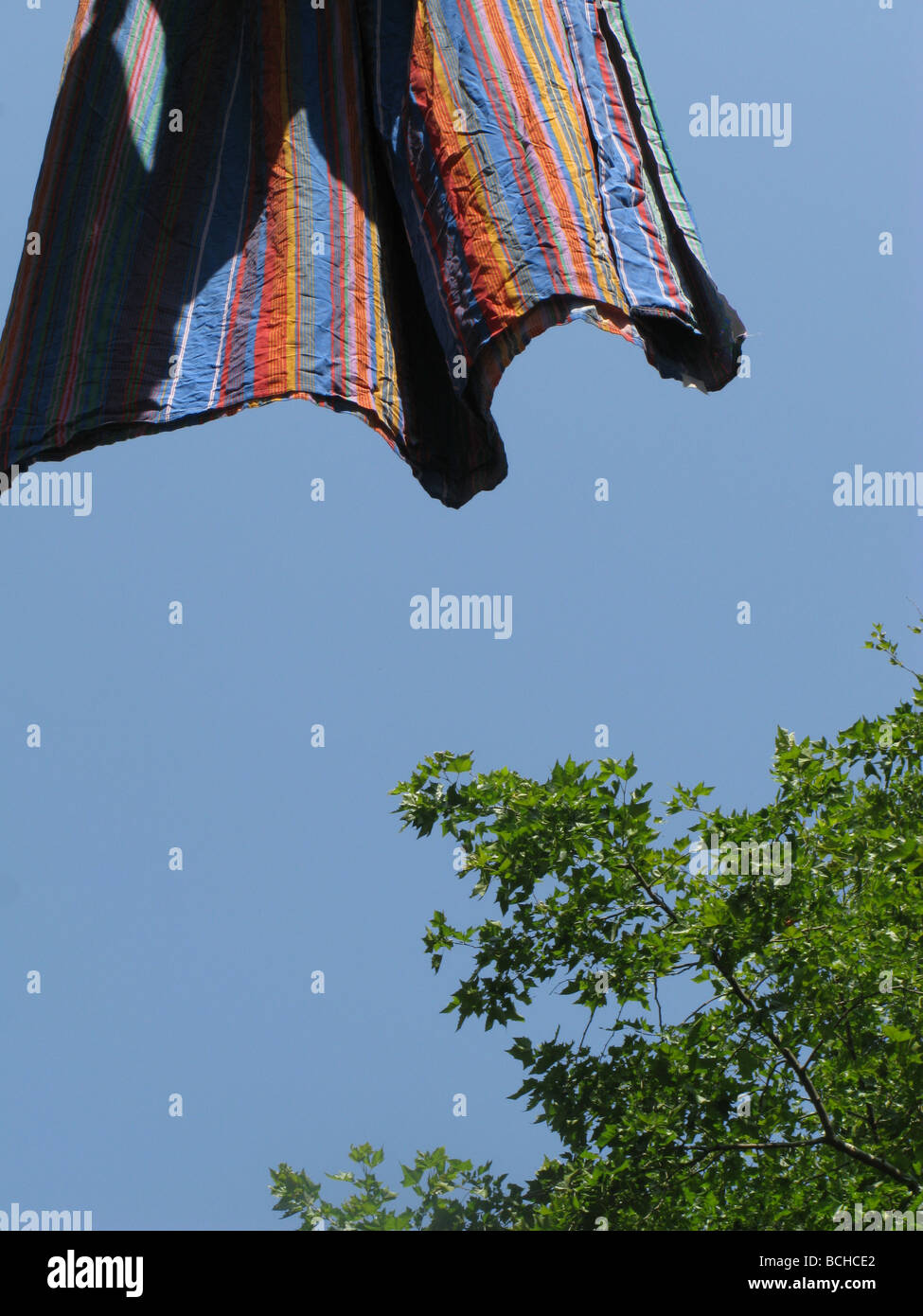 stripes bed sheet hanging on washing line in sun Stock Photo - Alamy