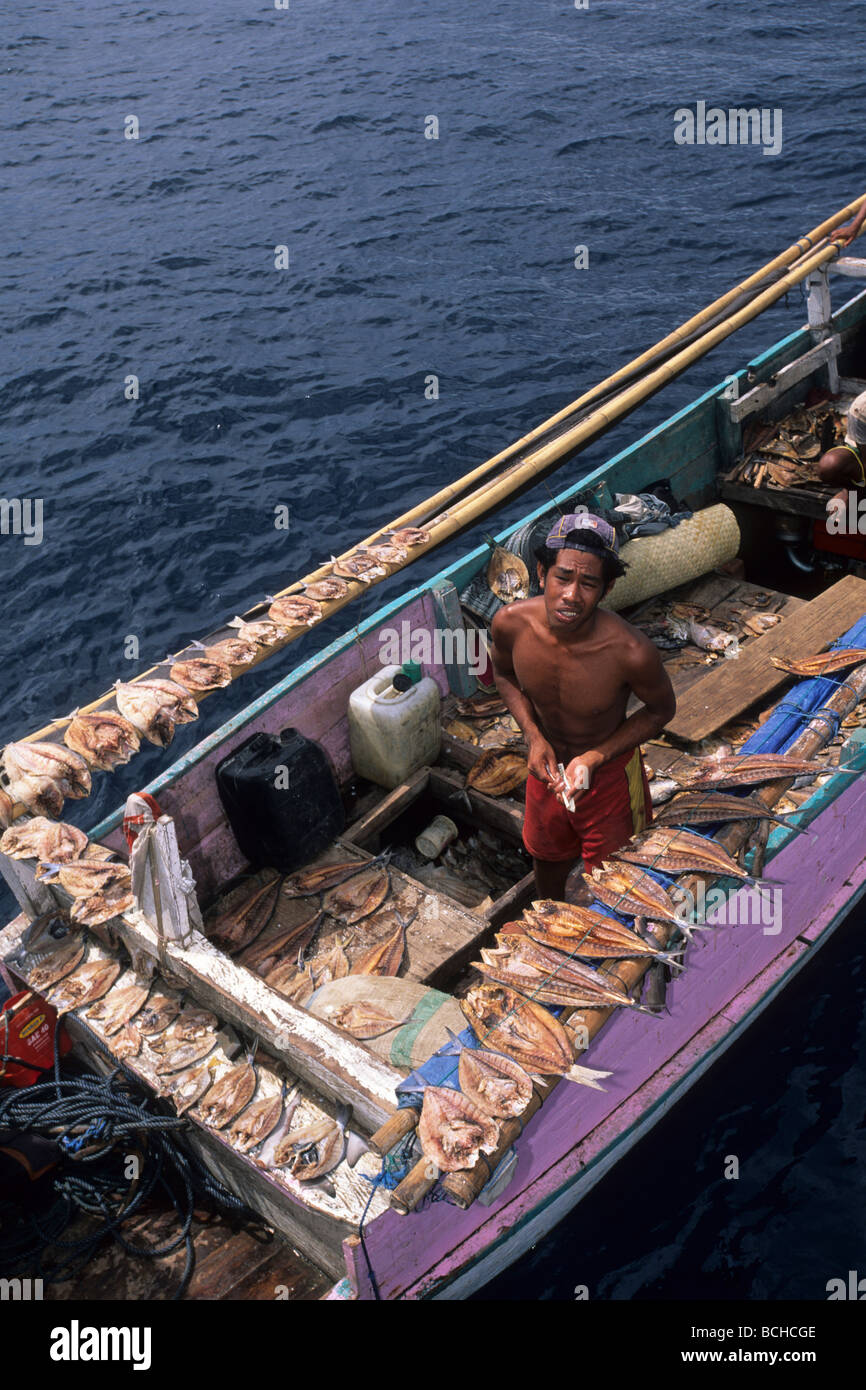 Fisherman drying Fish on his Boat Komodo National Park Lesser Sunda ...