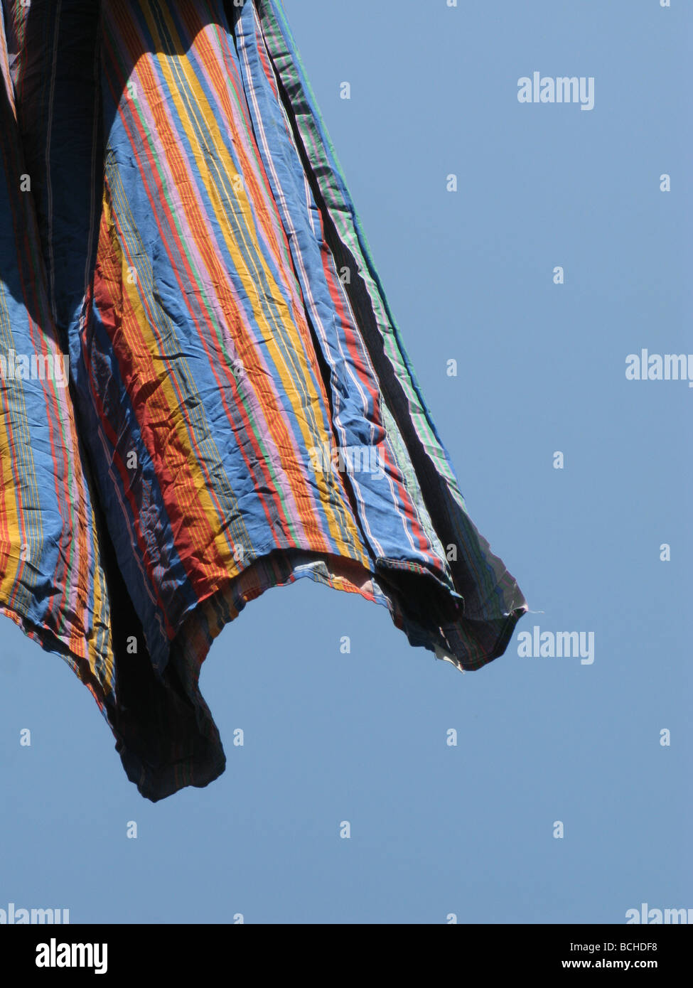 stripes bed sheet hanging on washing line in sun Stock Photo - Alamy