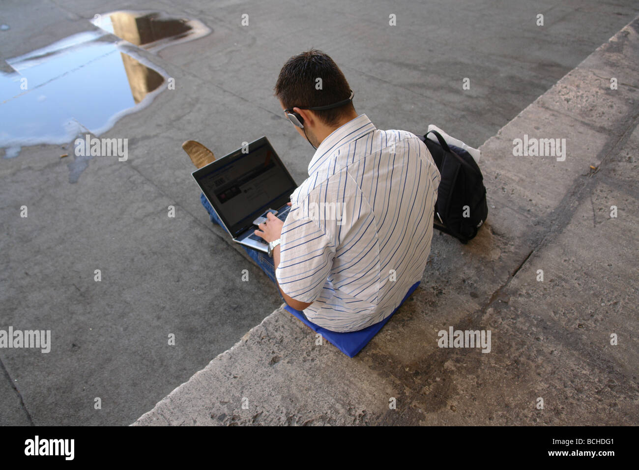 Young man work with computer outdoor Stock Photo - Alamy