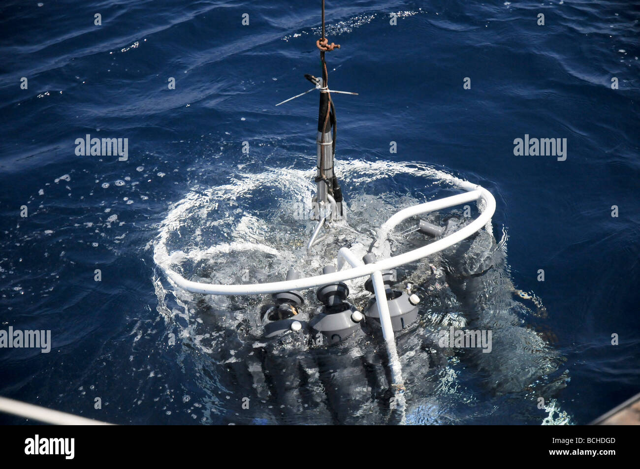 Oceanographers lowering a Niskin bottle rosette into the sea Stock ...