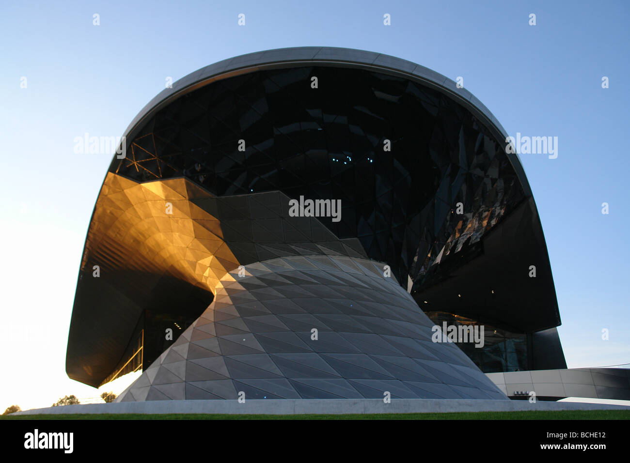Futuristic architecture of the new BMW world at dusk Munich Germany ...