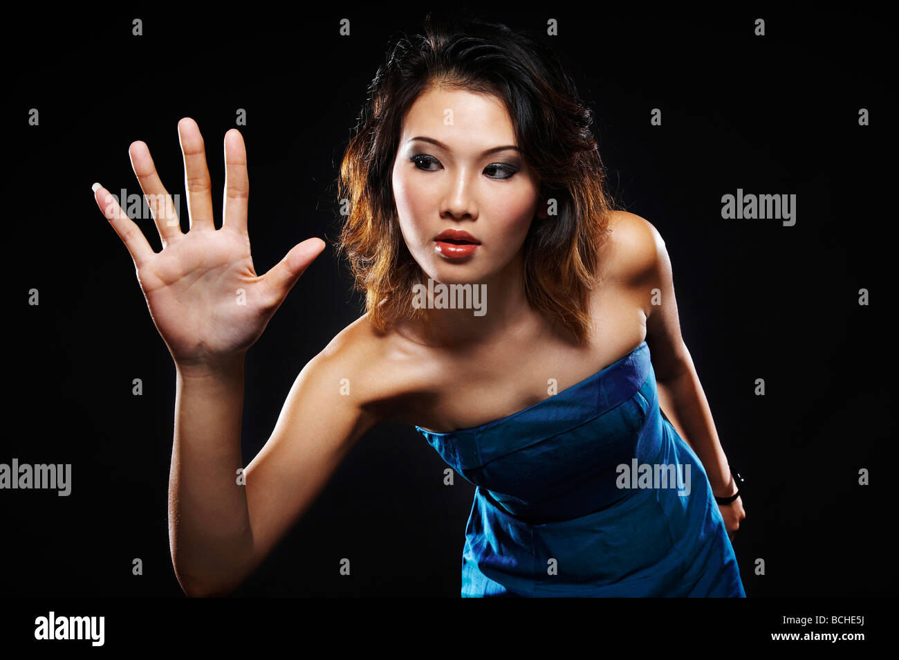 woman raising arm with the stop sign Stock Photo - Alamy