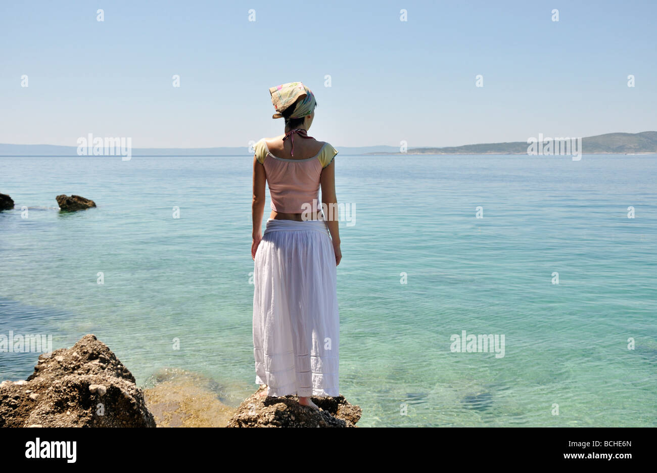 Woman standing on rocks looking hi-res stock photography and images - Alamy