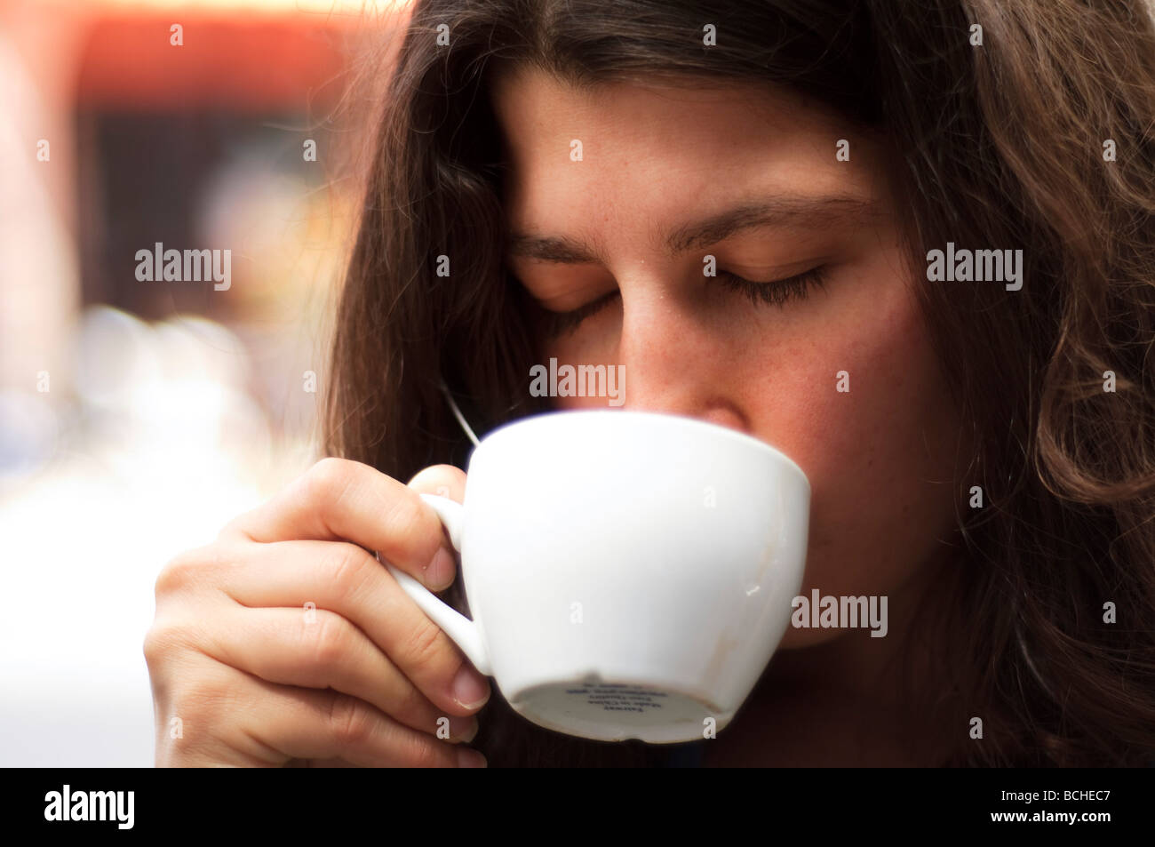 Young woman drinking coffee Model release available Stock Photo - Alamy