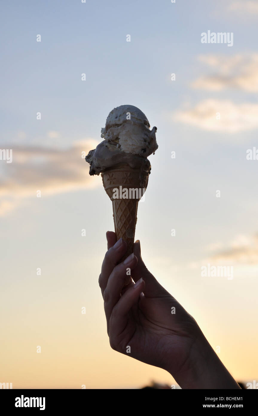 Hand holding ice cream cone Stock Photo - Alamy