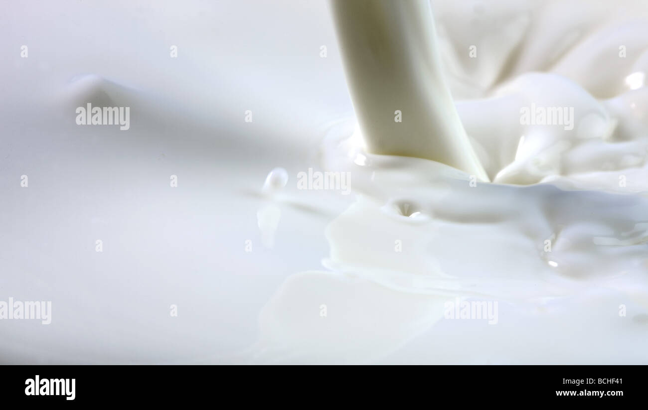 pouring fresh milk into a transparent glass Stock Photo - Alamy
