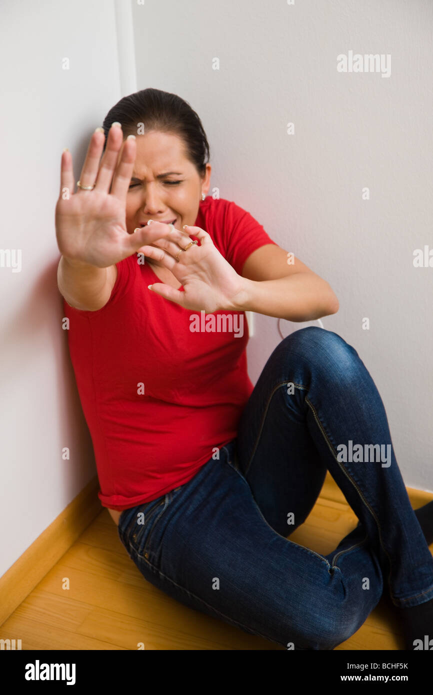 Timid woman symbol of violence in the family Stock Photo - Alamy