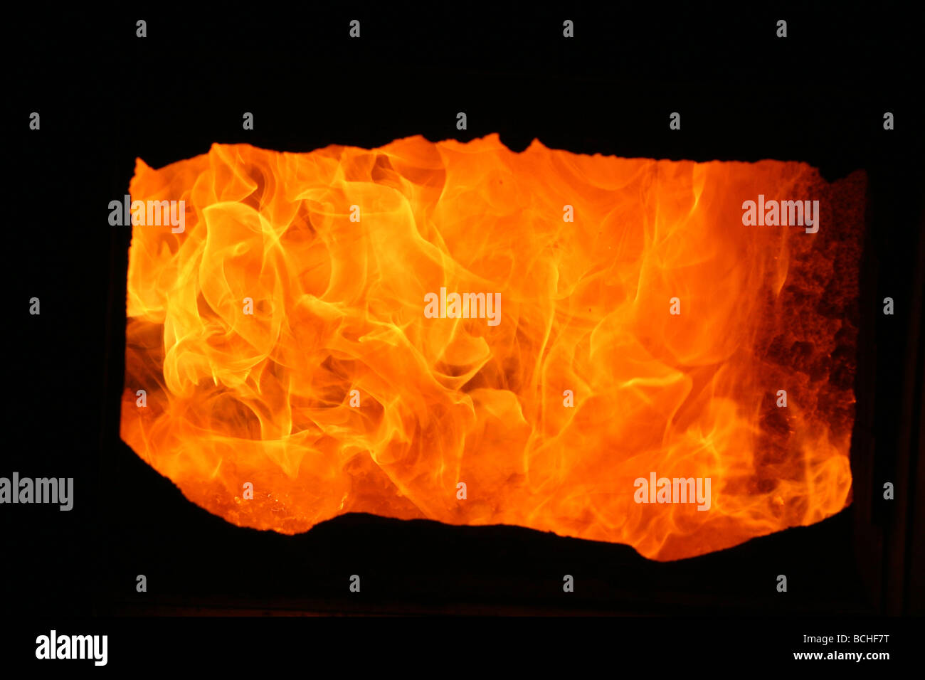 view into the red blazing fire of a hot stove Stock Photo - Alamy