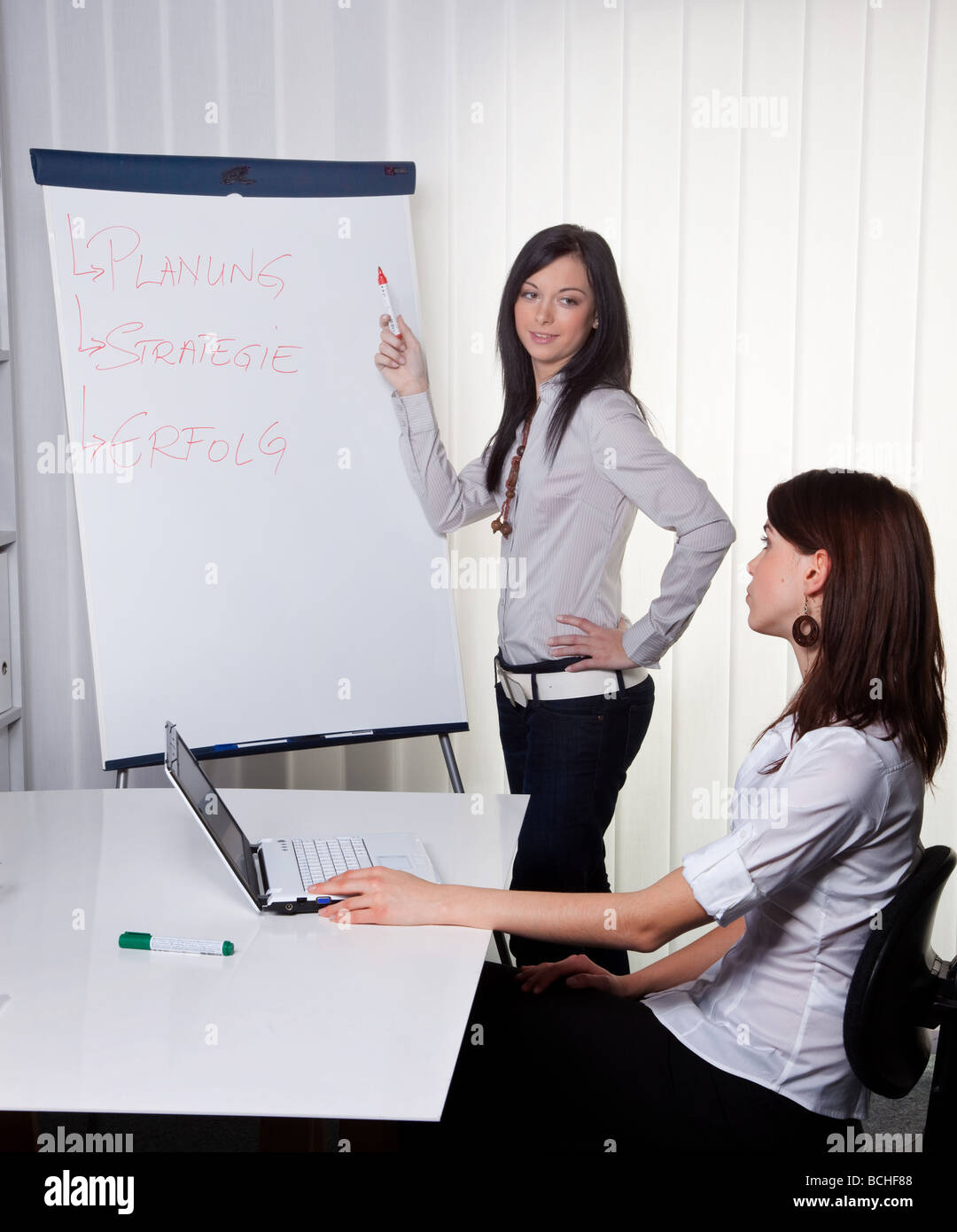 Young women in a business coaching explains model of success Stock ...