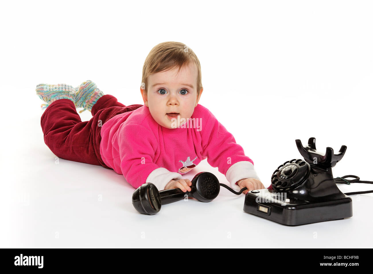 Lying little child plays with an old phone Stock Photo - Alamy