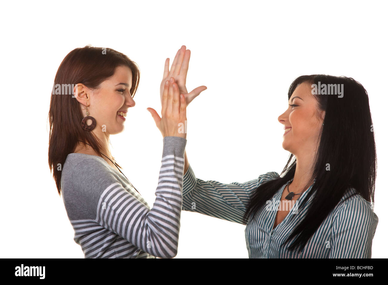 Two young girls handshake and agree Stock Photo - Alamy