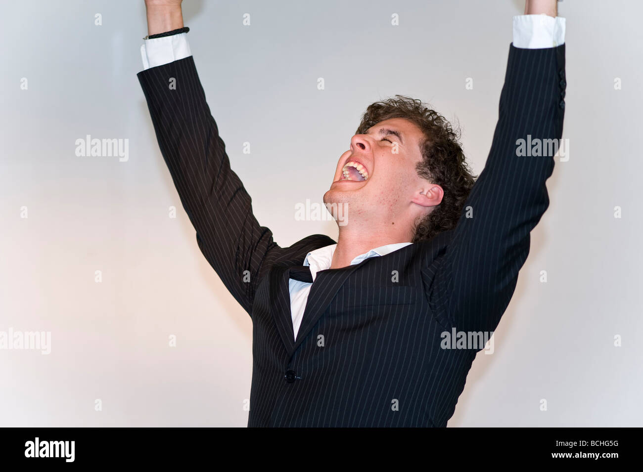 young business man cheers Stock Photo - Alamy