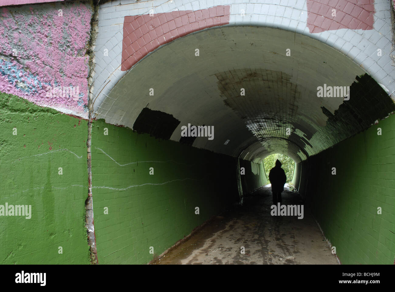 Person passing through tunnel Stock Photo - Alamy