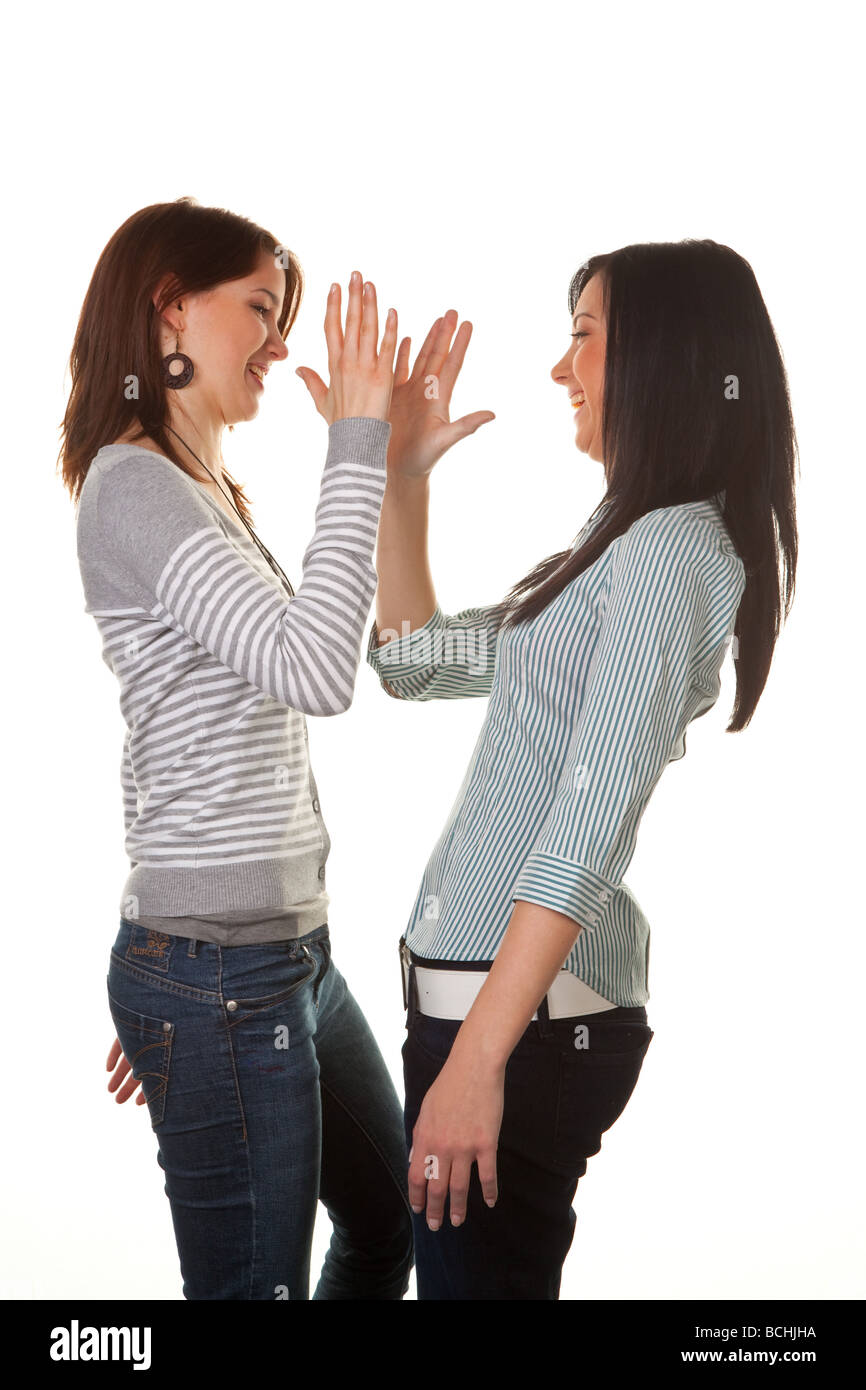 Two young girls handshake and agree Stock Photo - Alamy