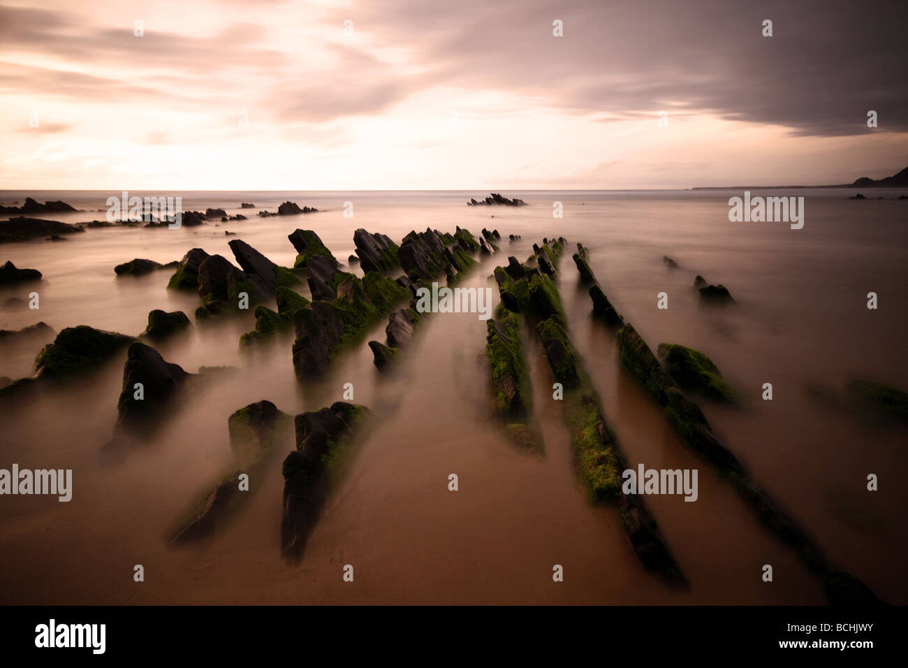 Tranquil scene long exposure on a beautiful beach with its aligned ...