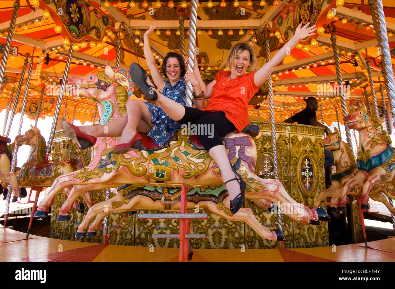 Girls on roundabout hi-res stock photography and images - Alamy