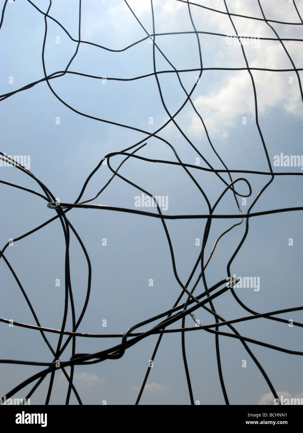 damaged metal wire fence and dark sky outdoors Stock Photo - Alamy