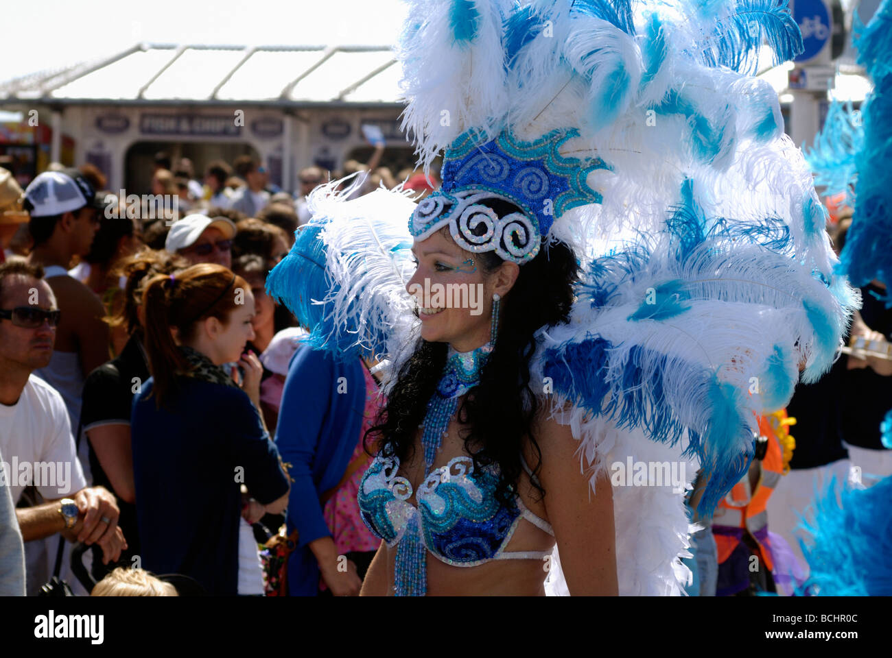 Woman in blue feather costume and headdress in street parade Stock ...