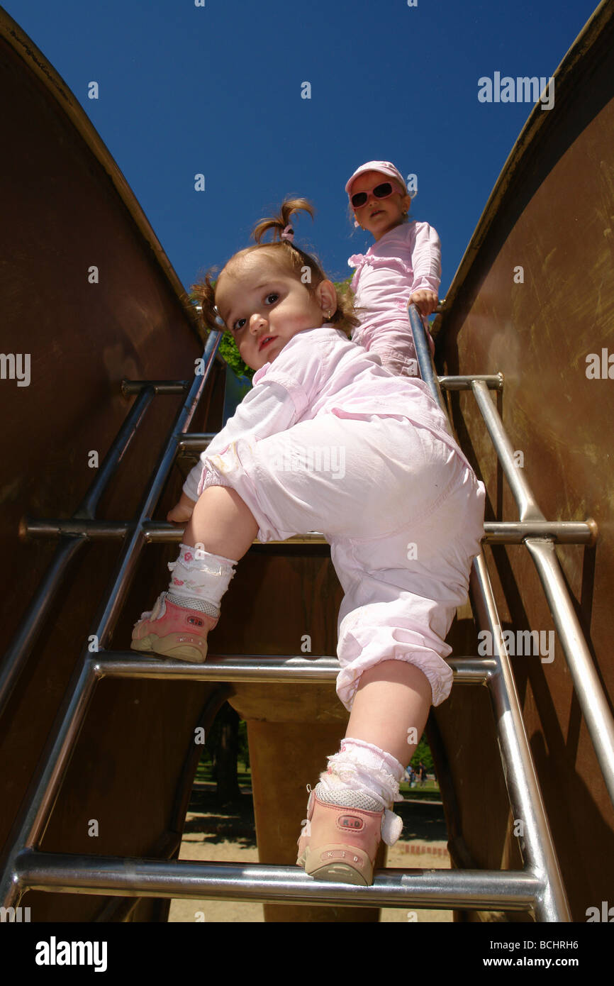 Girl climbing up slide hi-res stock photography and images - Alamy