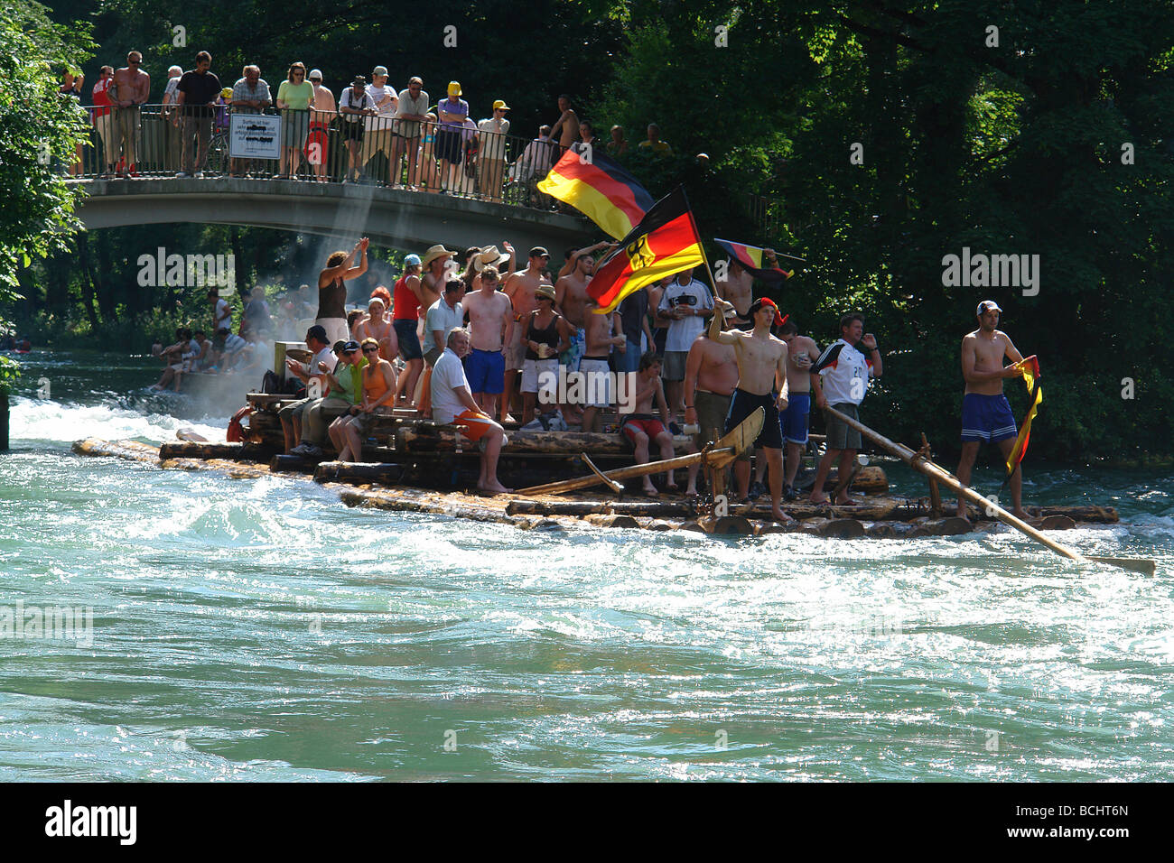 Happy sunday daytripper on a taditional Bavarian wooden raft on canal ...