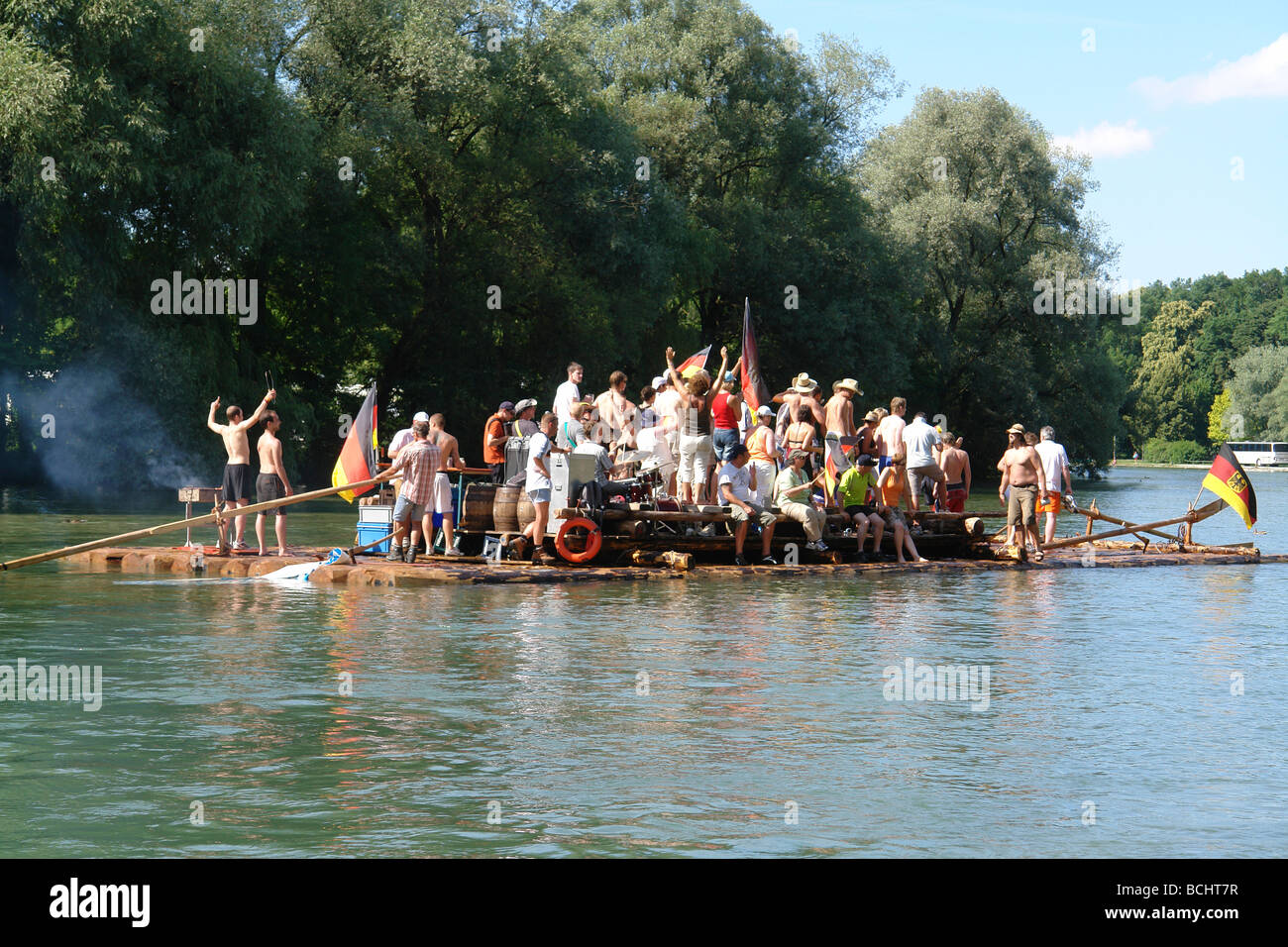 Happy sunday daytripper on a taditional Bavarian wooden raft on canal ...