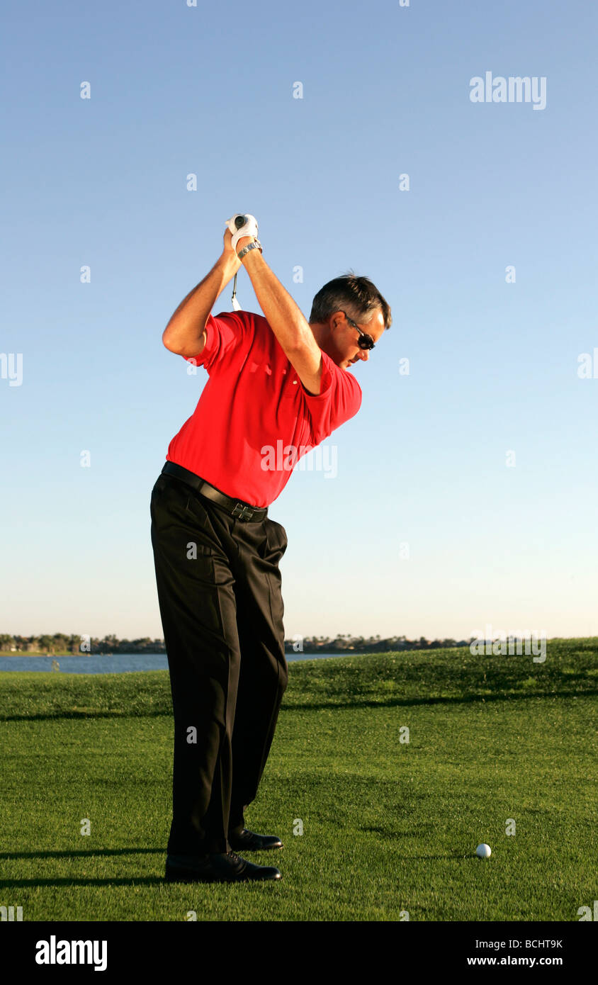 A Golfer prepares to hit a shot with an Iron Stock Photo - Alamy