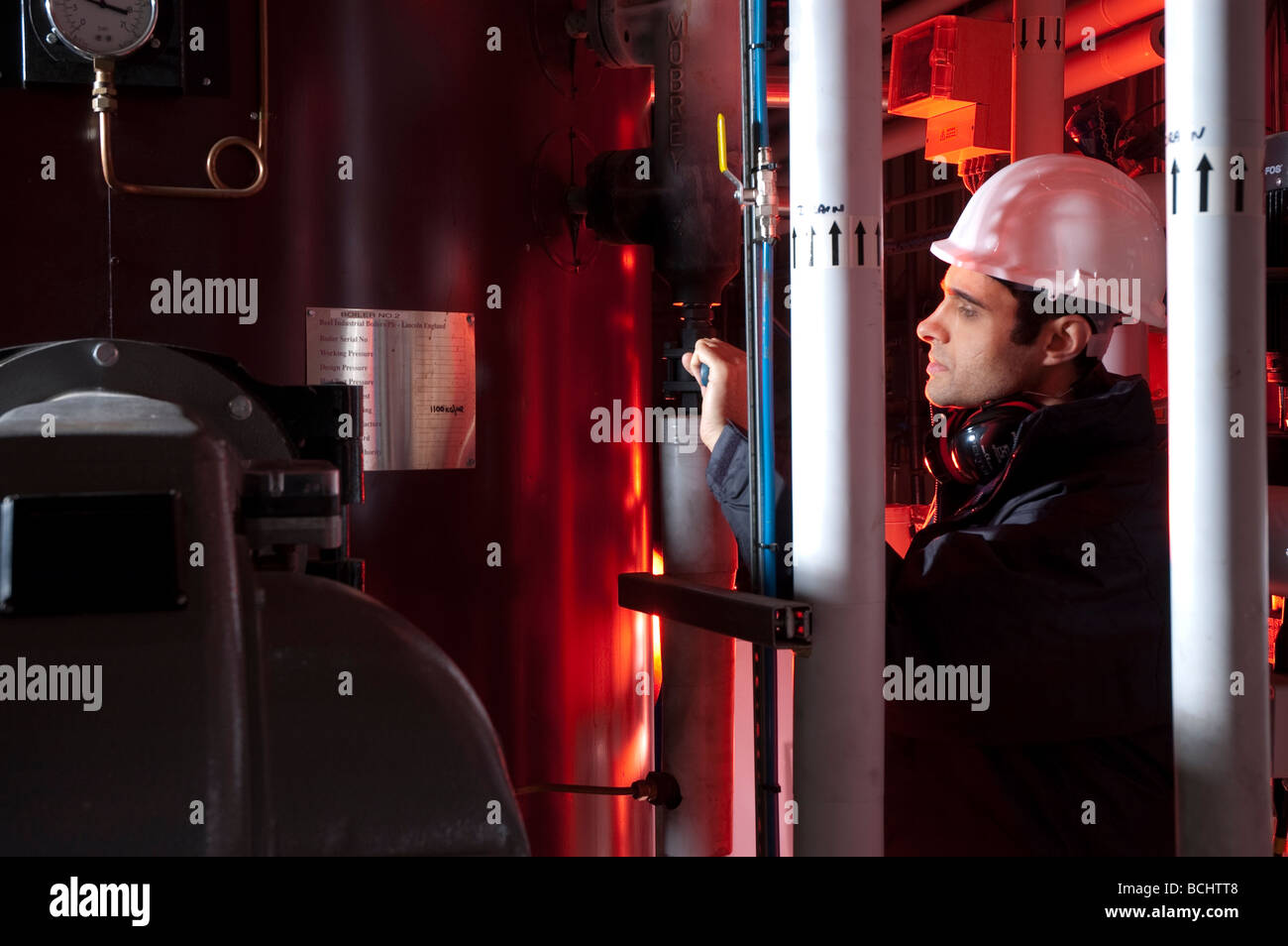 Engineer working on plant room industrial boilers Stock Photo - Alamy