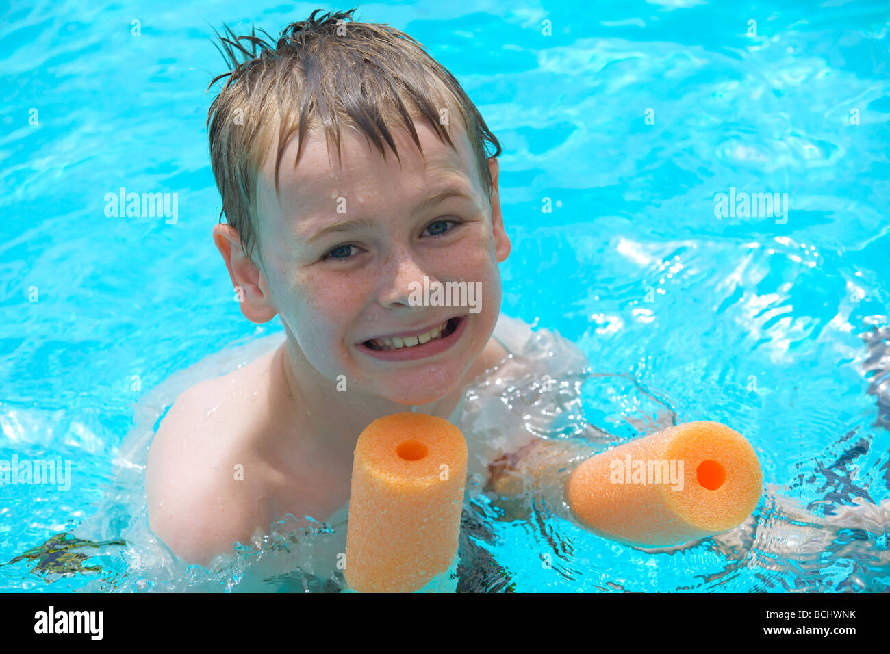 Happy young boy playing in the swimming pool Stock Photo - Alamy
