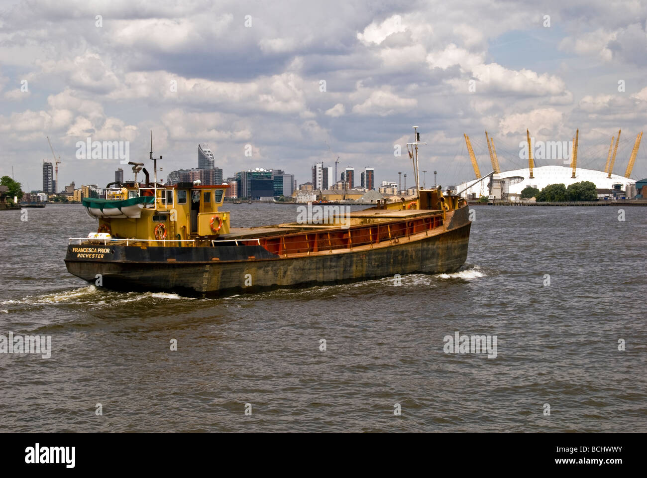 Large barge boat sailing along the River Thameswith O2 arena in ...