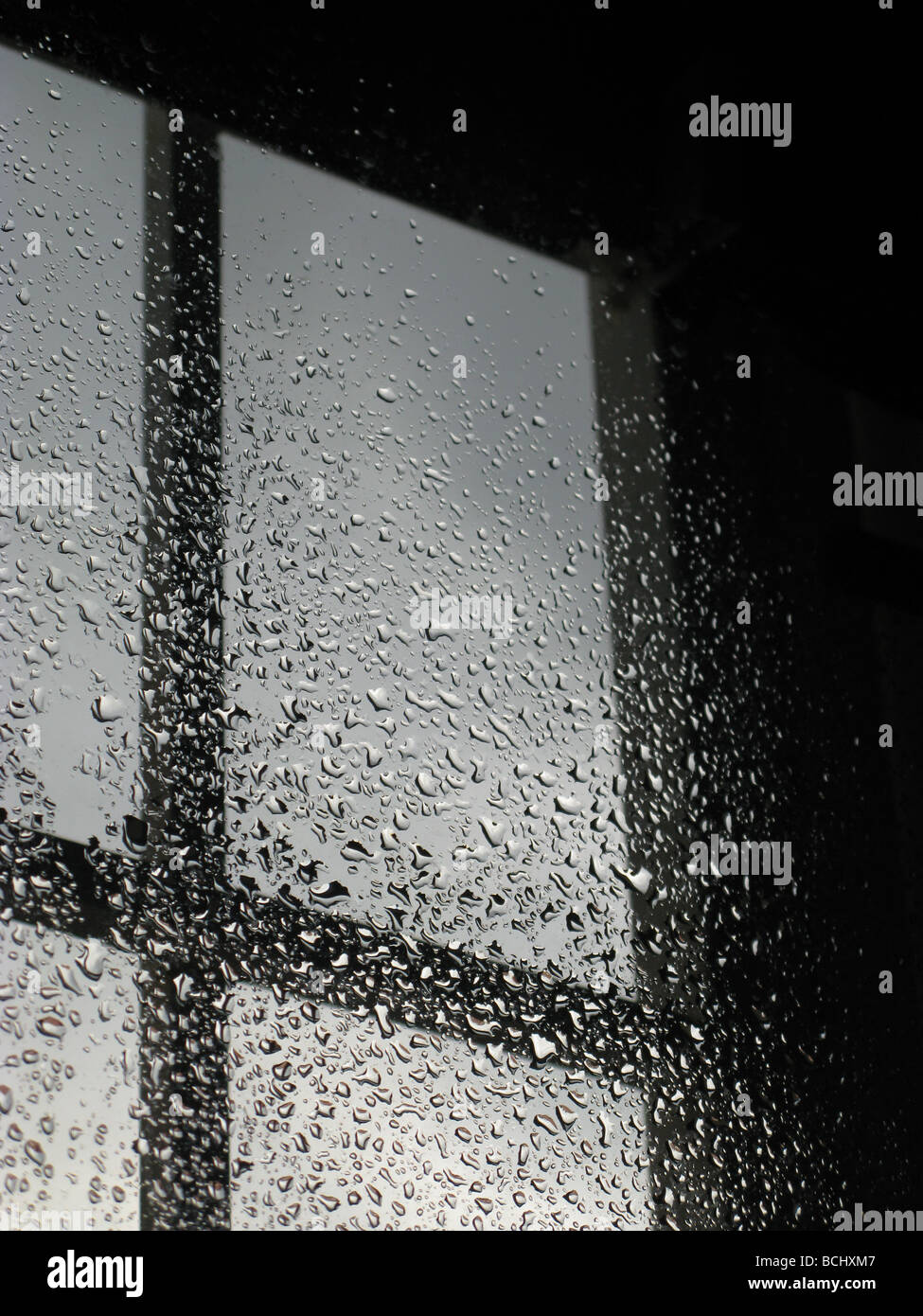 rain drops covered window seen from inside dark room Stock Photo - Alamy