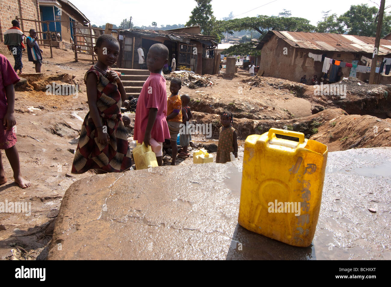 Children collecting water from contaminated spring. Kamwockya Kampala ...
