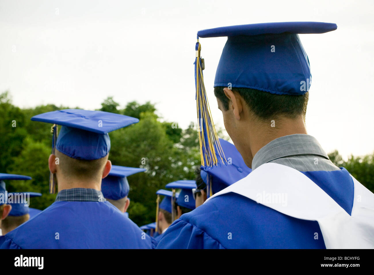 High School students wearing blue and gold cap and gown attend ...