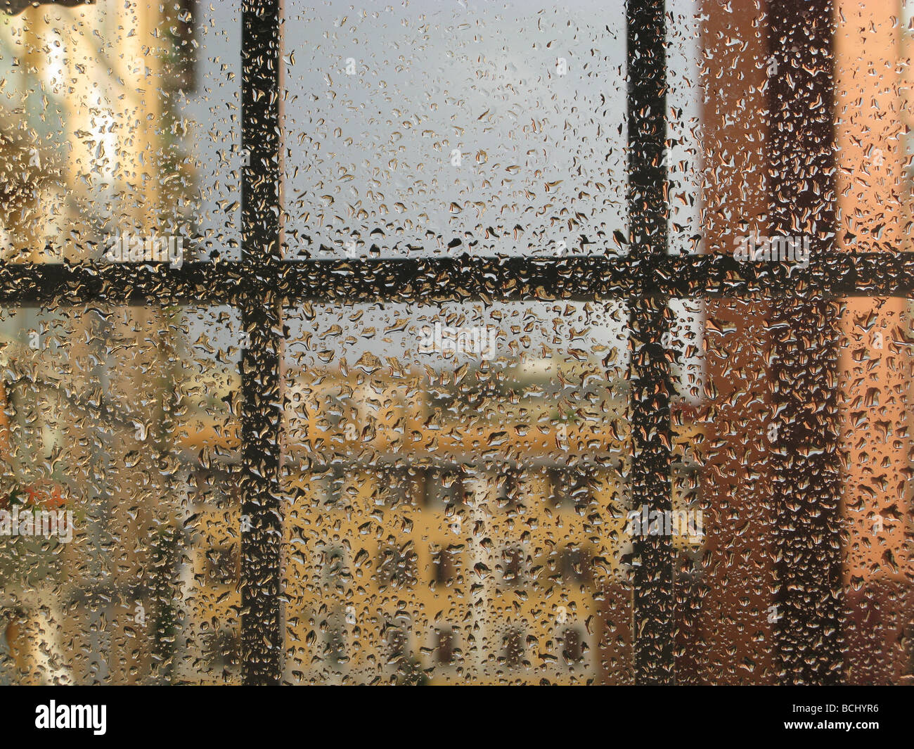 modern buildings seen through rain drops covered window Stock Photo - Alamy