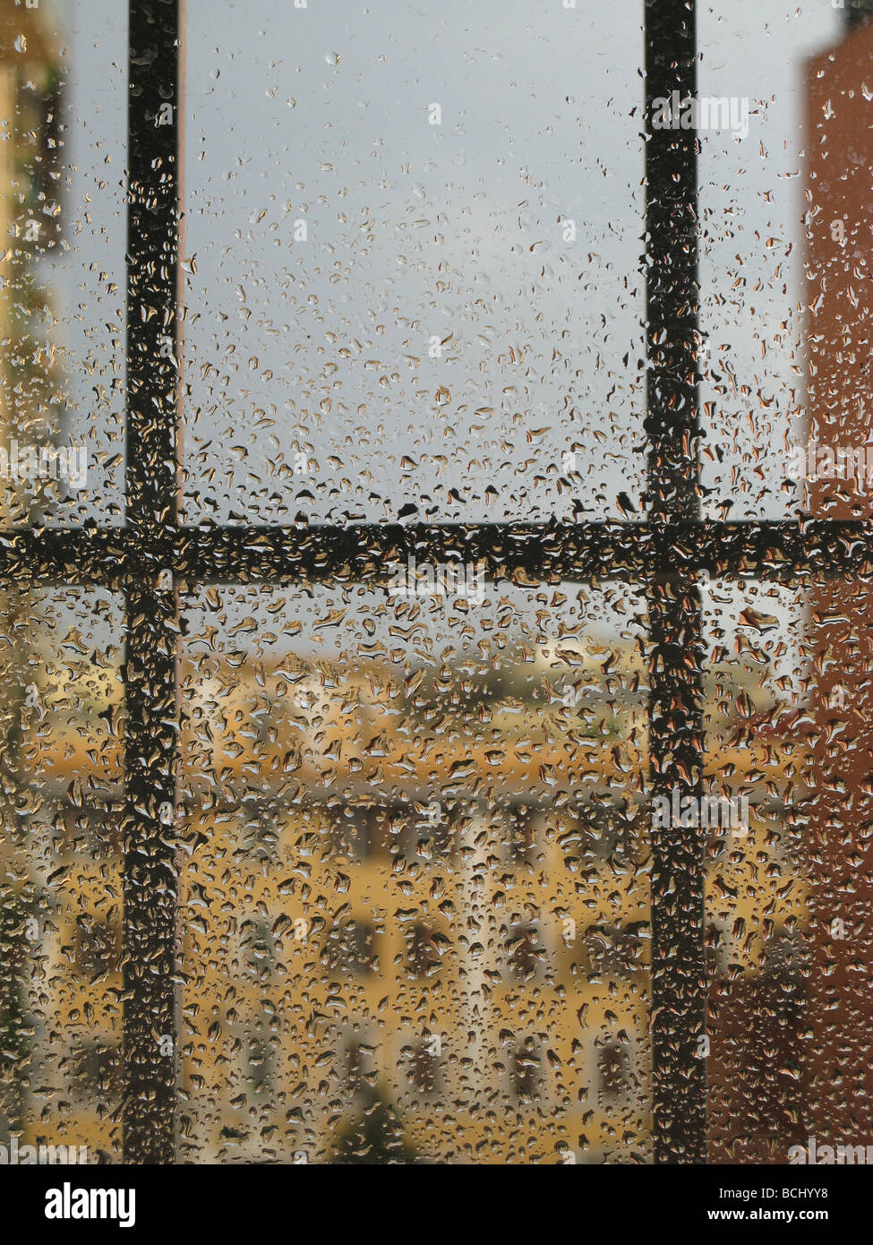 modern buildings seen through rain drops covered window Stock Photo - Alamy