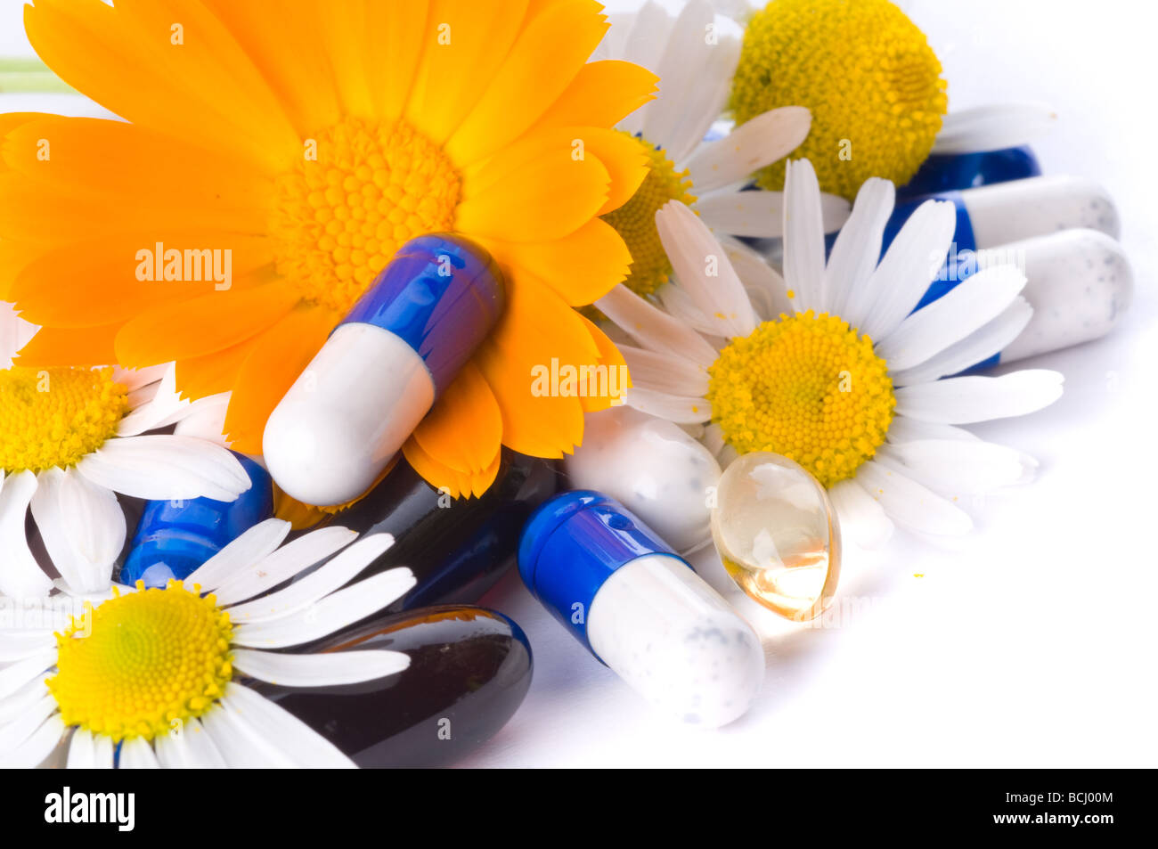 Tablets and flowers Herbal medicine Stock Photo - Alamy