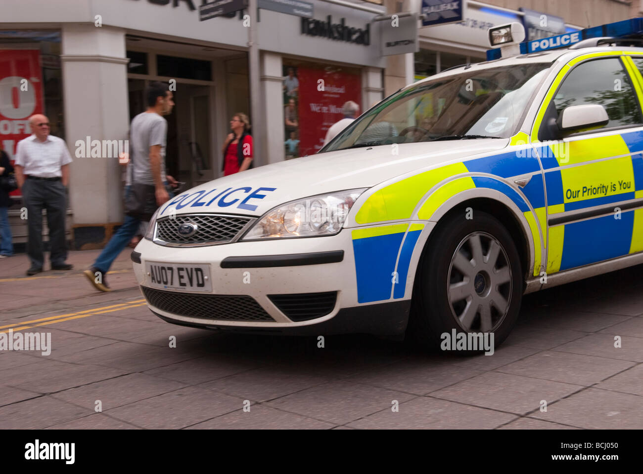 A Police car driving through the streets in Norwich Norfolk Uk showing ...