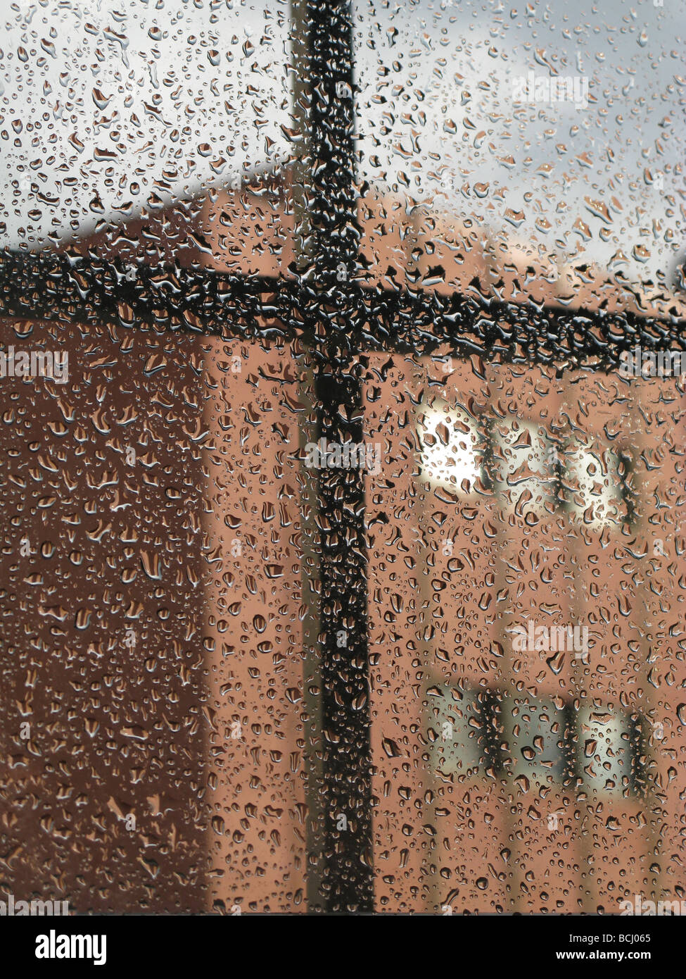 modern buildings seen through rain drops covered window Stock Photo - Alamy