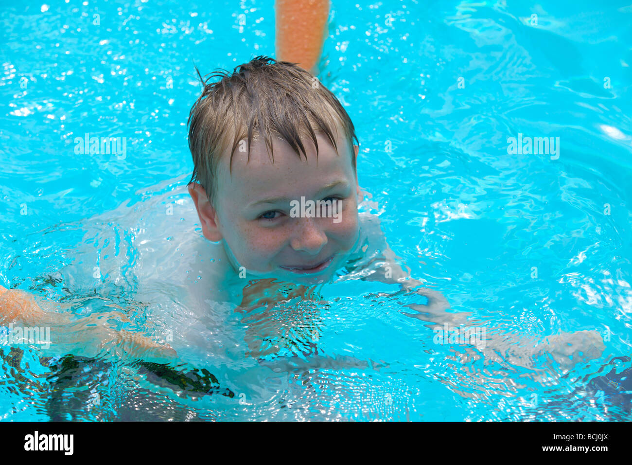 Happy Young Boy Playing In The Swimming Pool Stock Photo Alamy