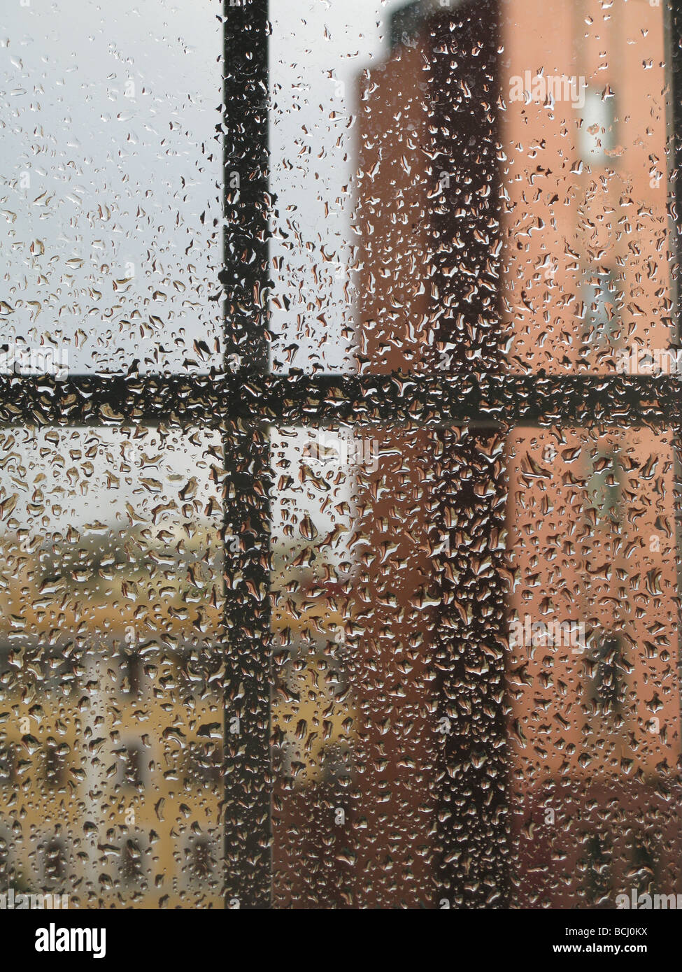 modern buildings seen through rain drops covered window Stock Photo - Alamy