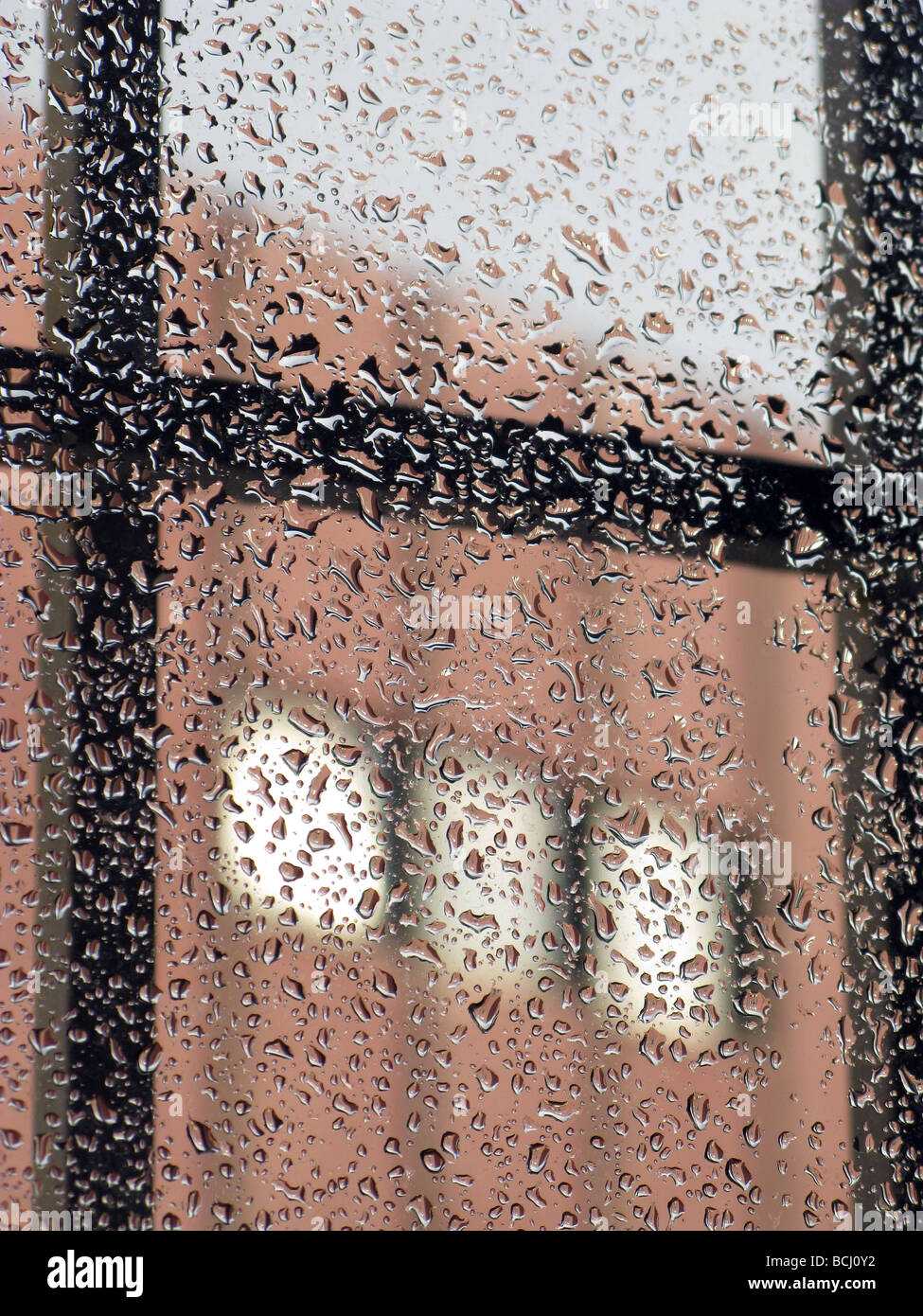 modern buildings seen through rain drops covered window Stock Photo - Alamy