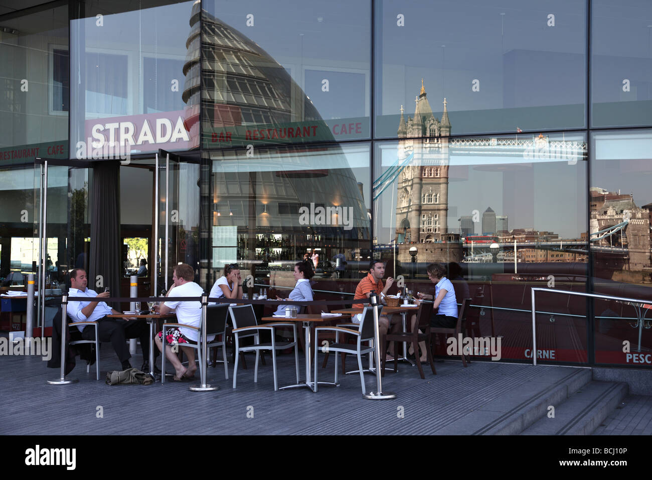Reflections of the Tower Bridge and City Hall in London, in the window ...