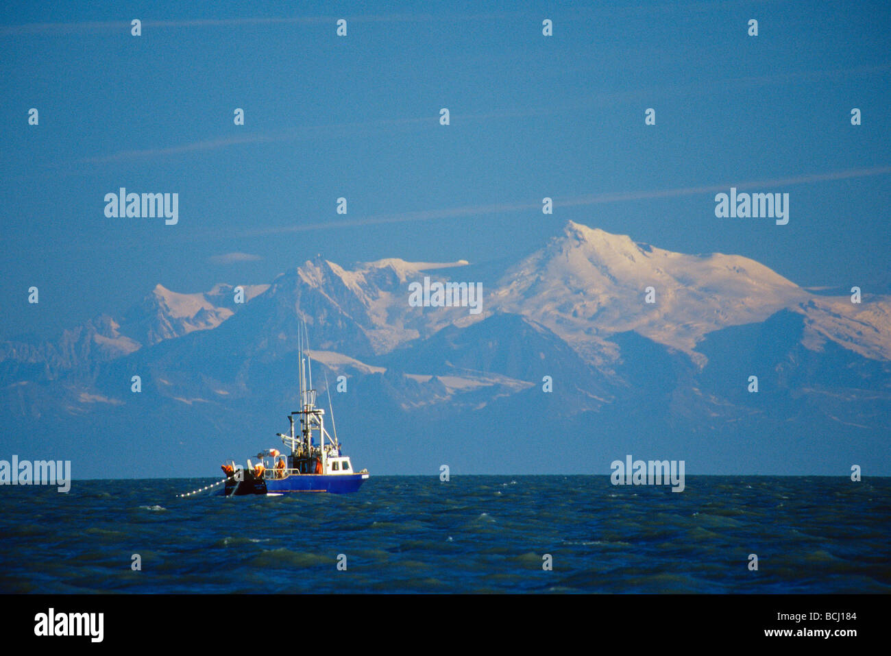 Commercial gillnet fishing boat in Cook Inlet below Mount Spur Neacola ...