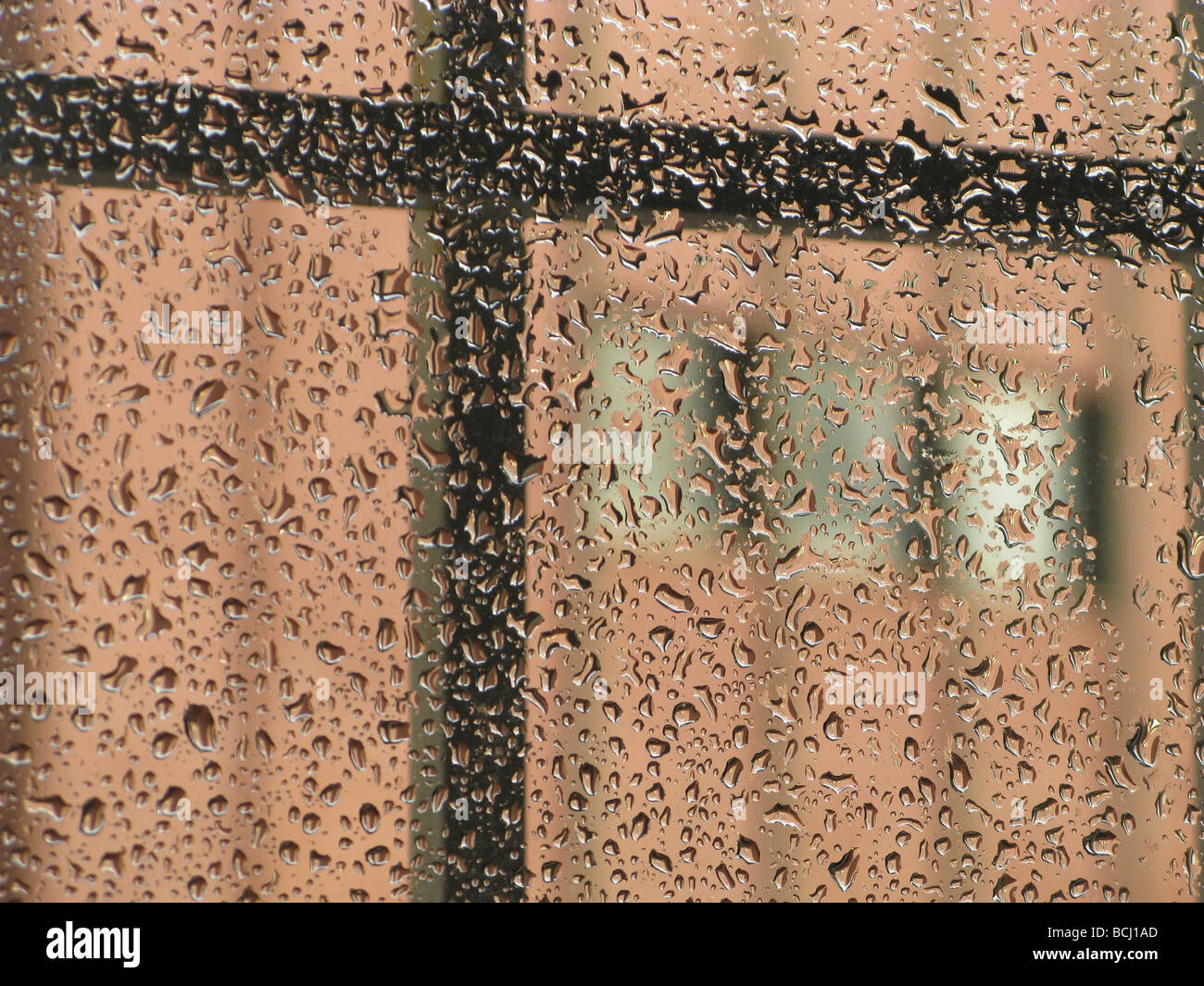 modern office block seen through rain drops covered window Stock Photo ...