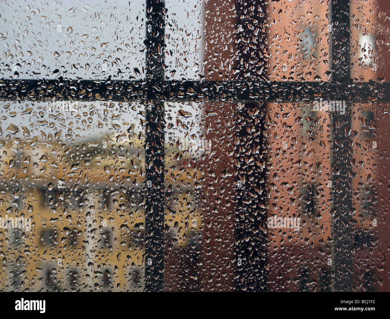 modern buildings seen through rain drops covered window Stock Photo - Alamy