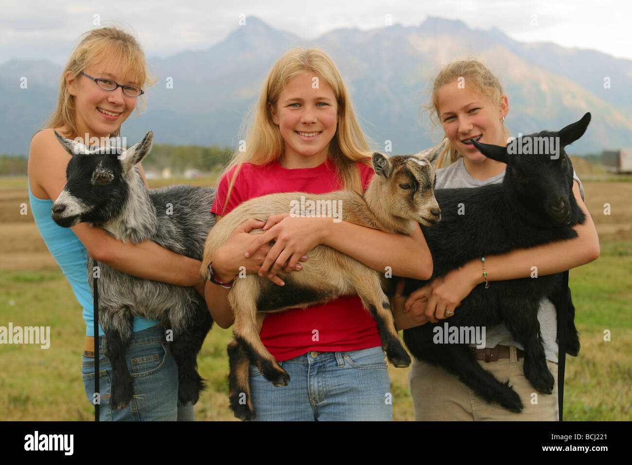 Three sisters holding goats at Alaska State Fair in the Mat-Su Valley ...