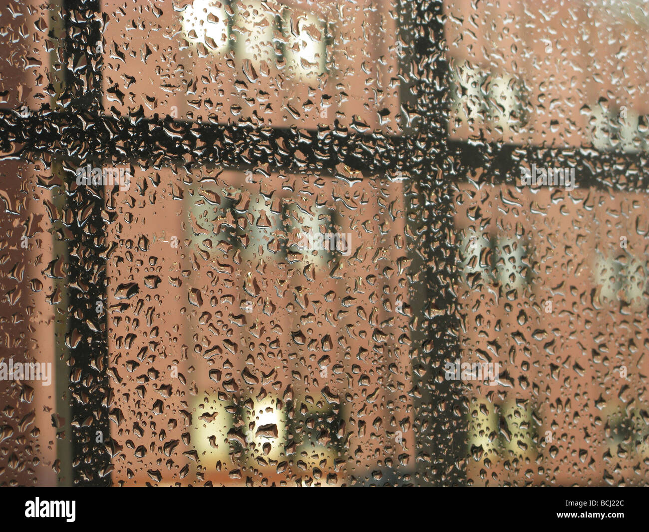 modern office block seen through rain drops covered window Stock Photo ...