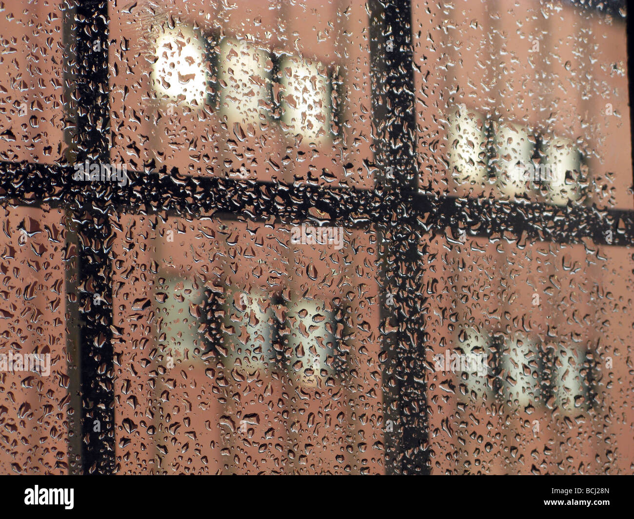 modern office block seen through rain drops covered window Stock Photo ...