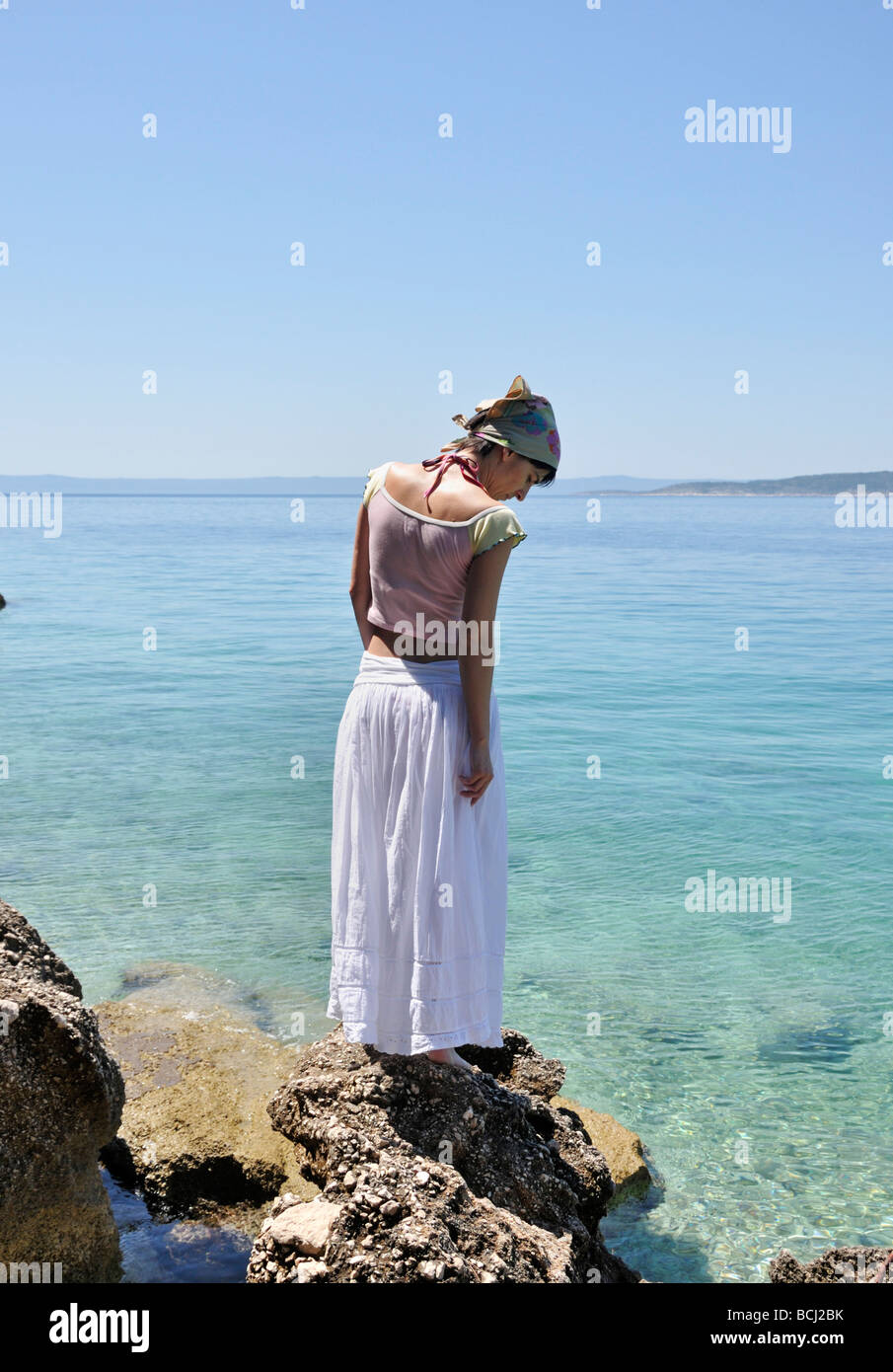 Woman at the rocks hi-res stock photography and images - Alamy
